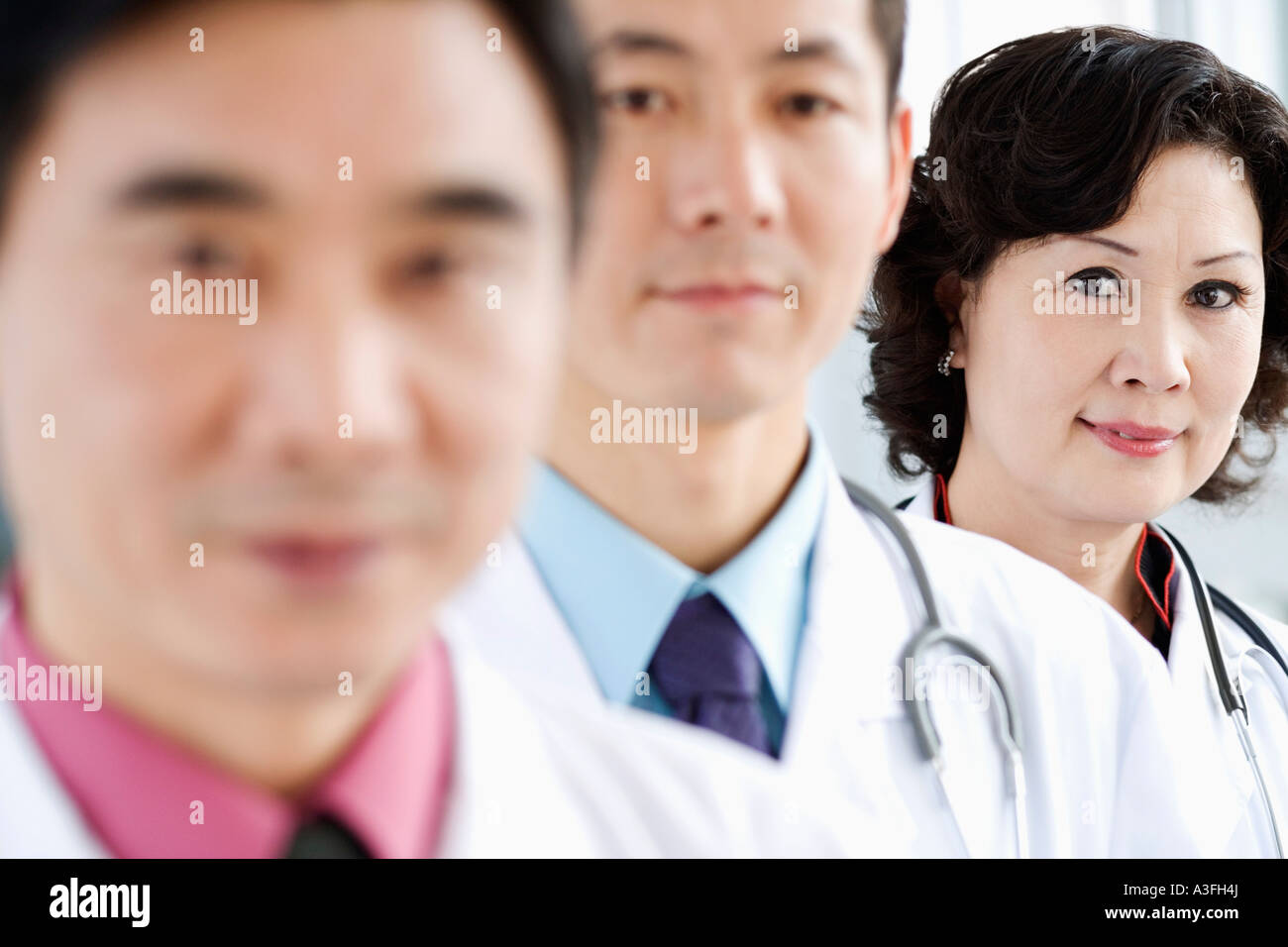 Portrait of two male doctors with a female doctor Stock Photo - Alamy