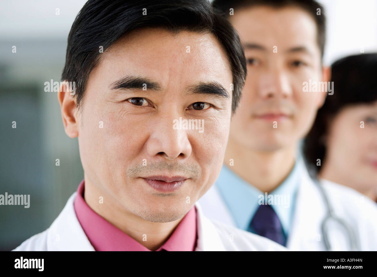 Portrait of two male doctors with a female doctor Stock Photo - Alamy