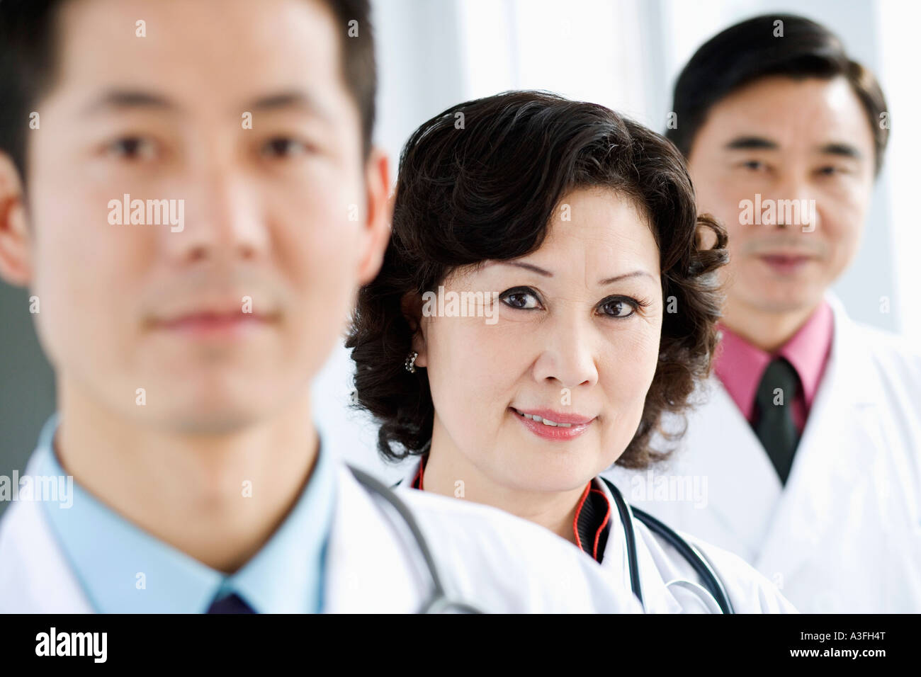 Portrait of two male doctors with a female doctor Stock Photo - Alamy