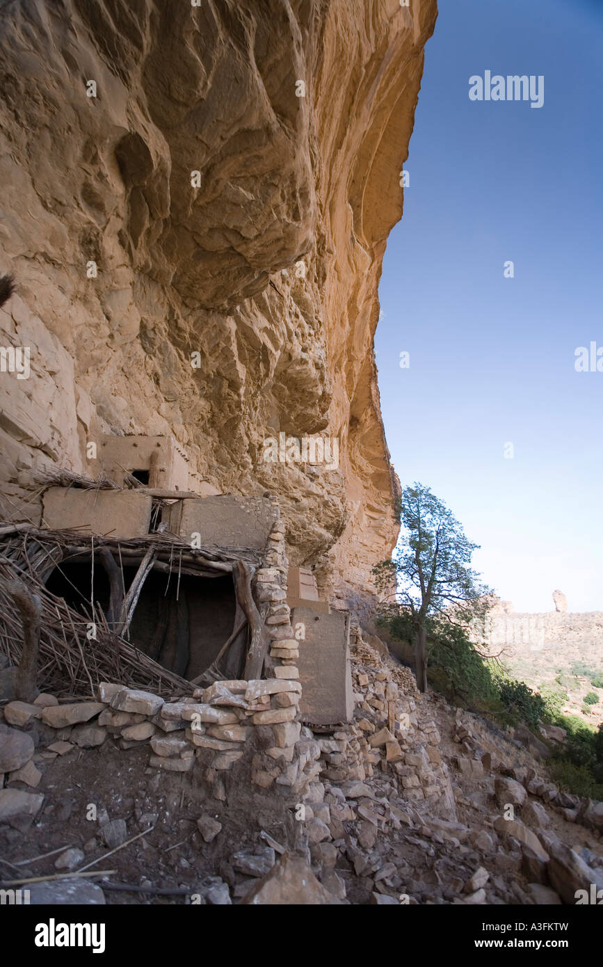 Crumbling abandoned Dogon houses under an overhang on the cliffside of ...