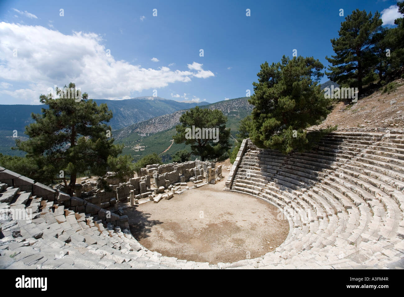 A ruined Roman amphitheater looks over a wooded valley in Arycanda ...
