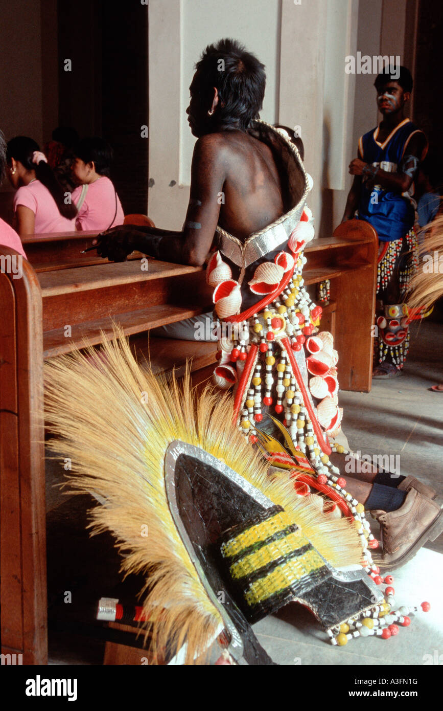 Philippines, Aklan, Kalibo, dressed up dancer recites on a pew in the ...