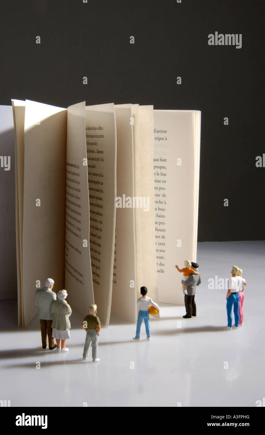 Figurines shaking hands on pile of books Stock Photo - Alamy