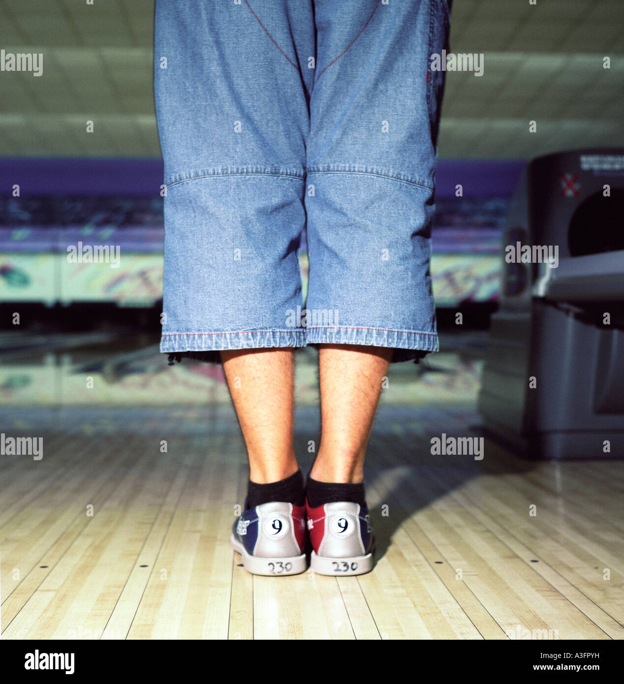 A young man stands on a ten pin bowling alley in Cyprus Stock Photo - Alamy