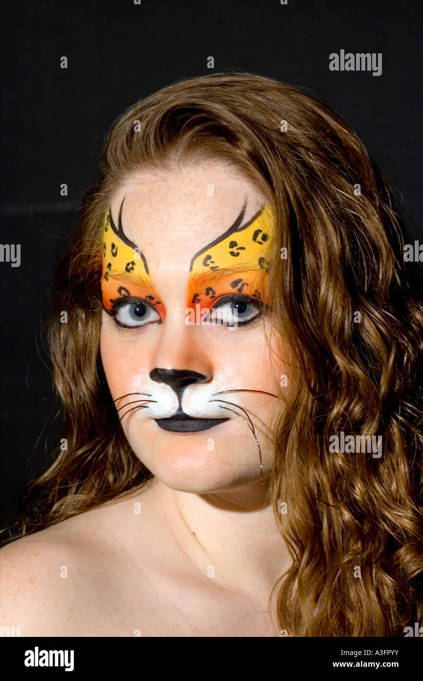 young teenage female model with elaborate tiger make up mask on black ...