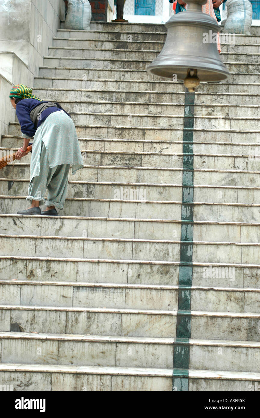 A woman sweeping the steps of the Hindu temple Stock Photo - Alamy