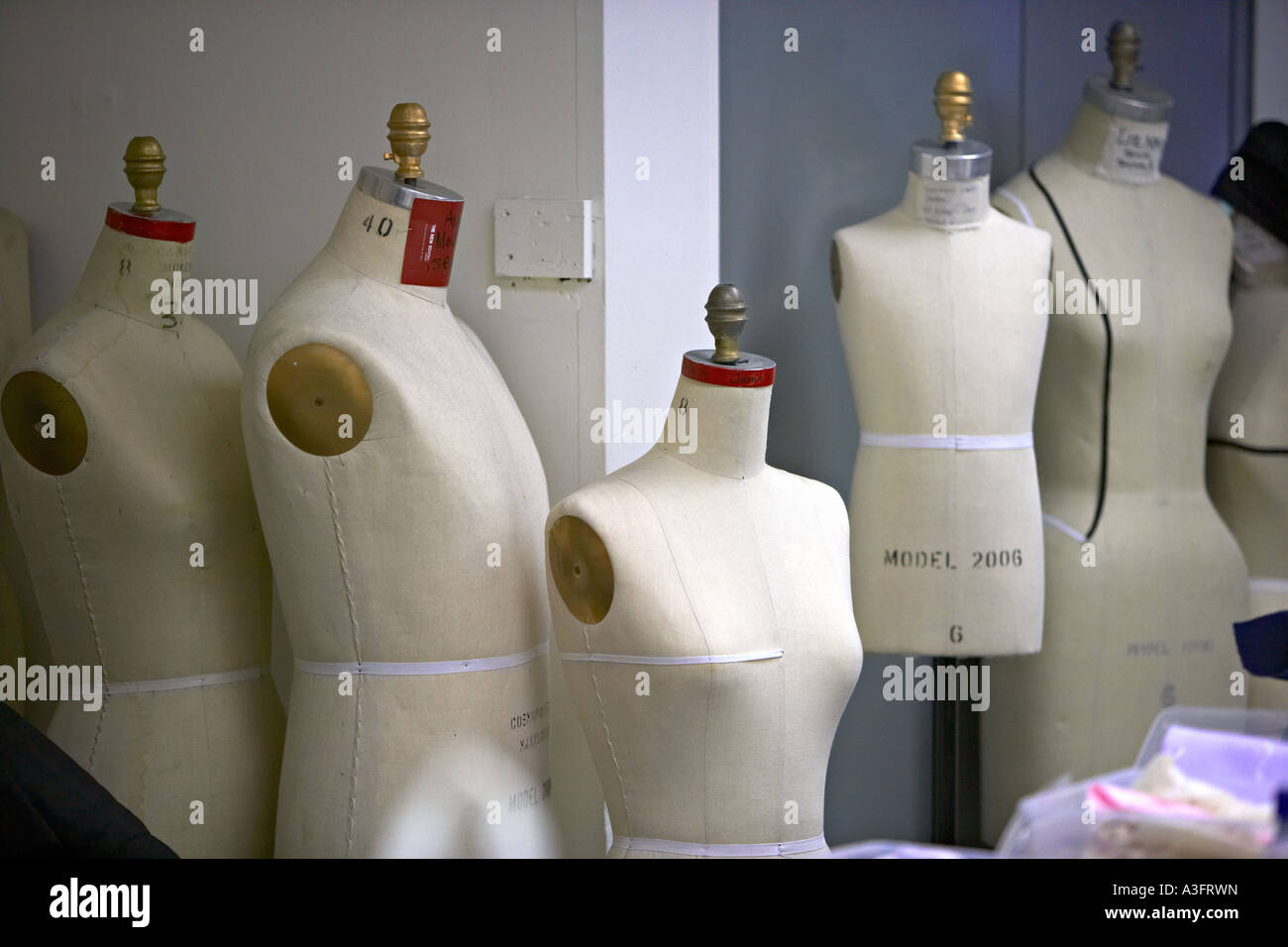 Fitting Manaquins lined up against a wall for dressmaking clothing ...