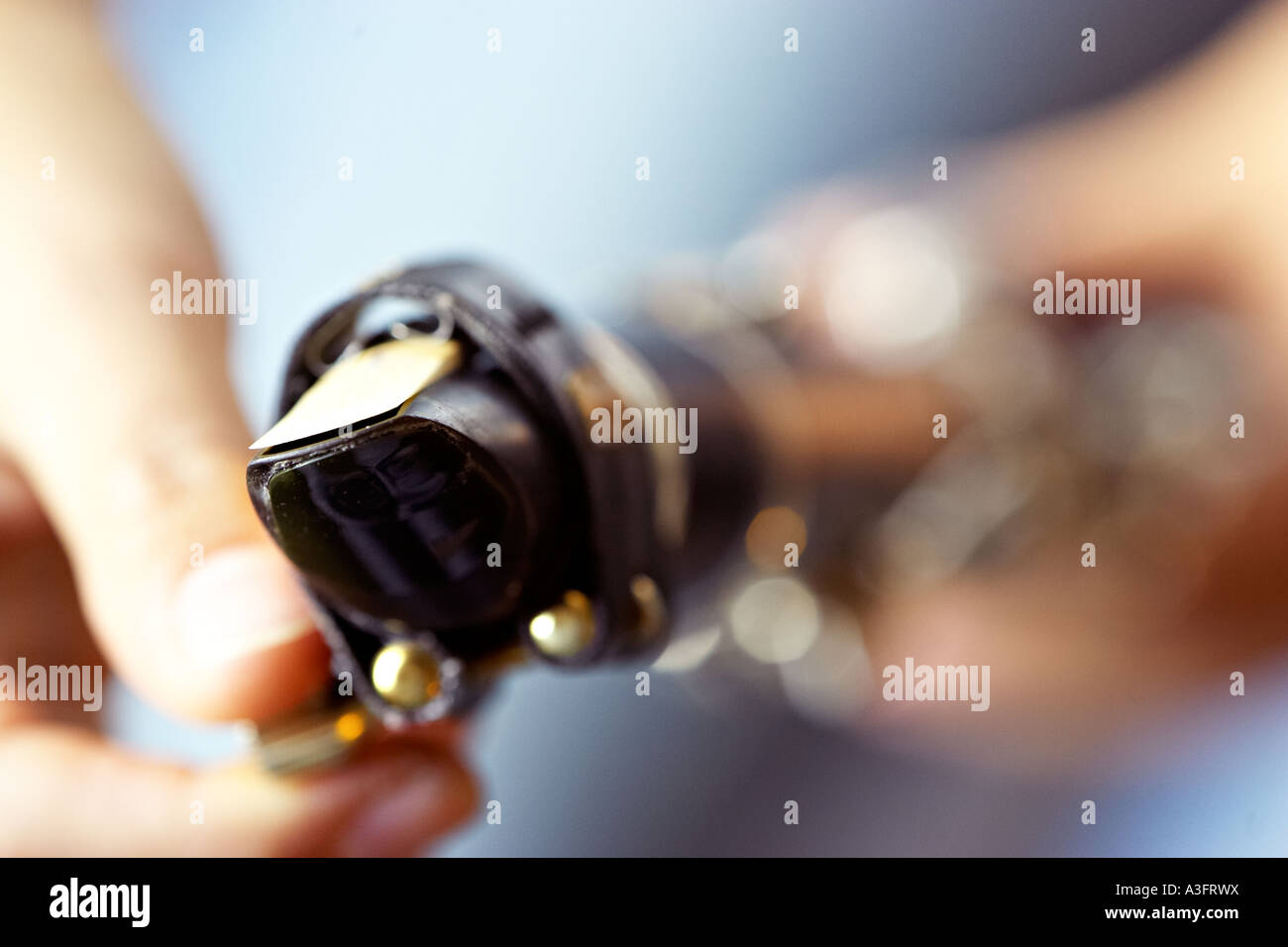 Musician adjusting the reed on a clarinet Stock Photo - Alamy