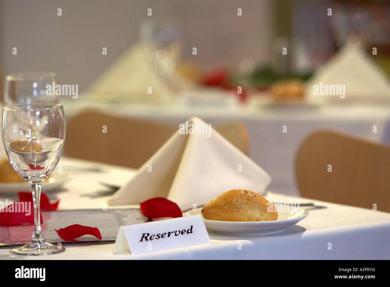 Table setting at a restaurant Paper placard on the table reads reserved ...