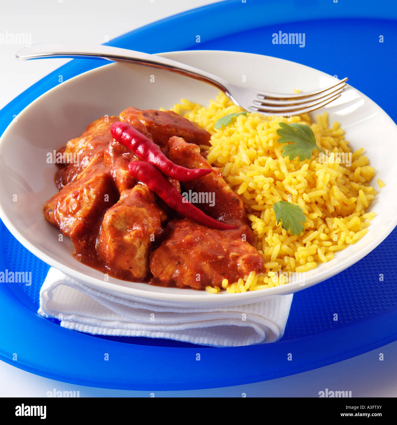 A plate of chicken rogan josh with saffron rice Stock Photo - Alamy