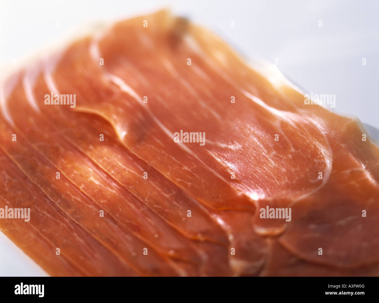 Slices of parma ham on a white background Stock Photo - Alamy