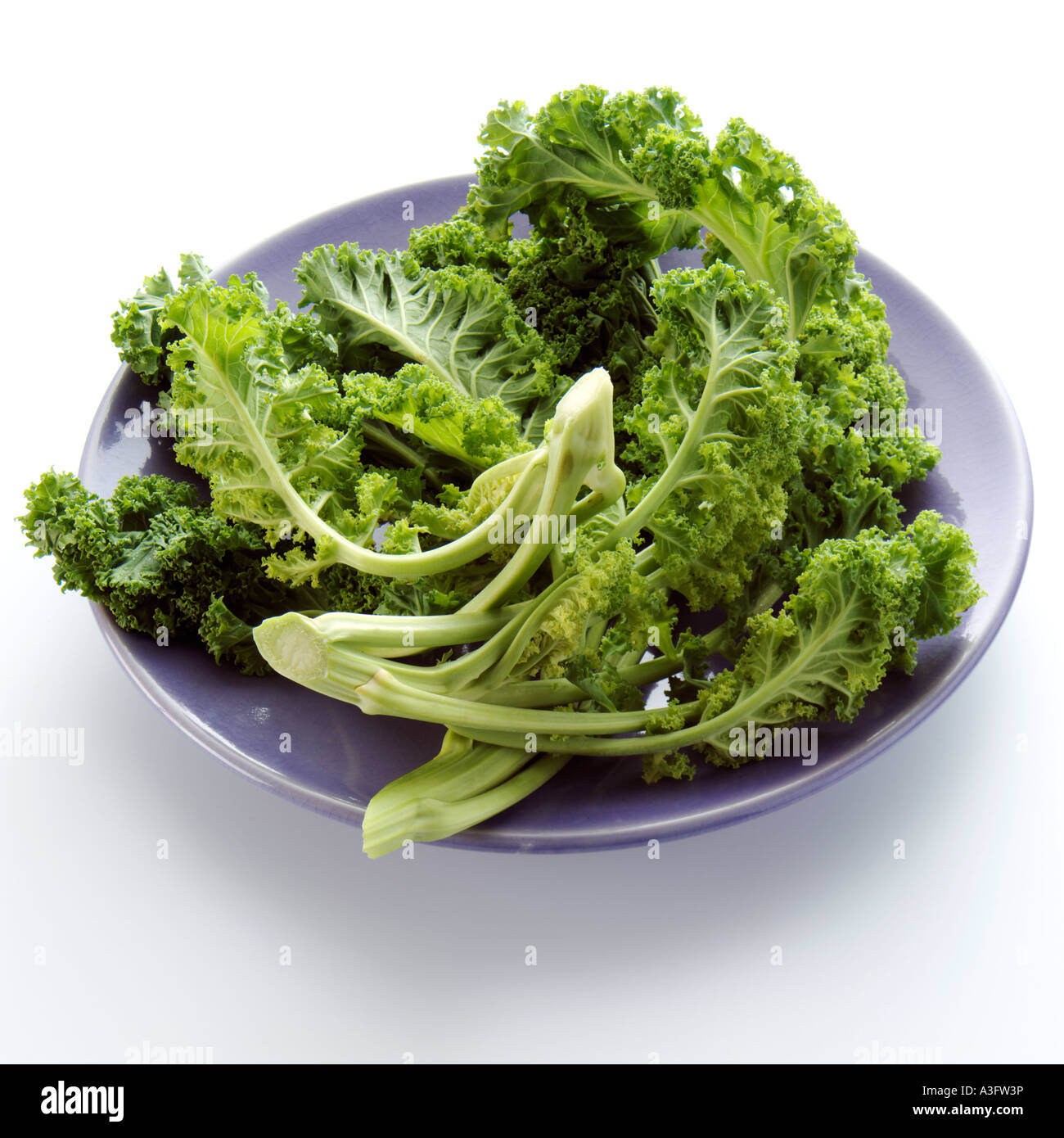 A bowl of kale on a white background editorial food Stock Photo - Alamy