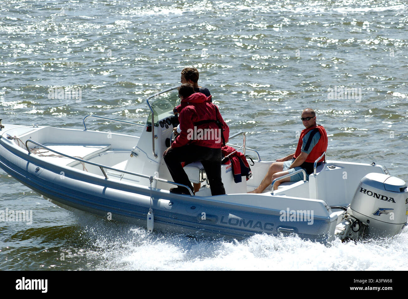 Men in speed boat Exmouth harbour Devon England UK Stock Photo - Alamy