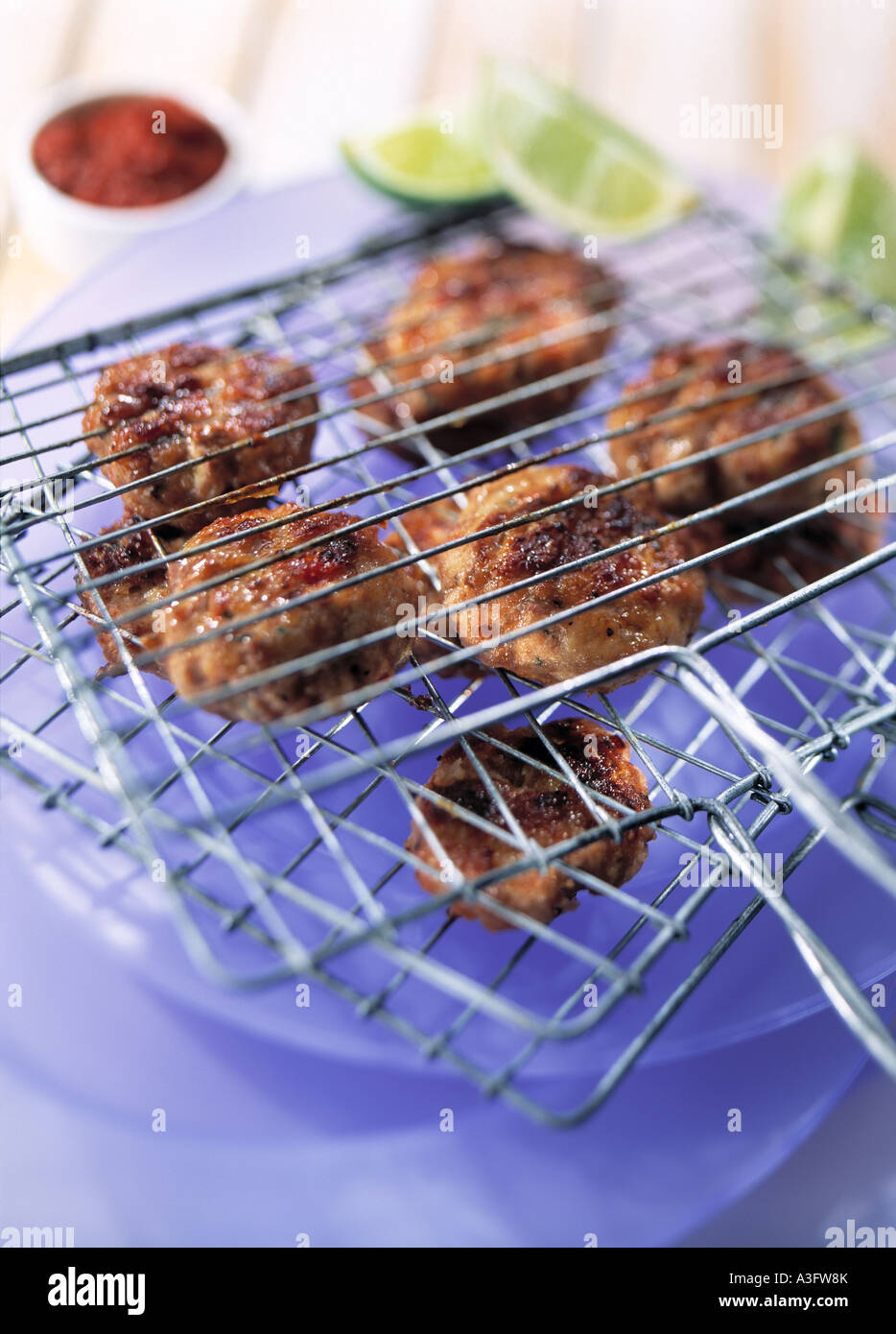 Burger on a BBQ grill rack editorial food Stock Photo - Alamy