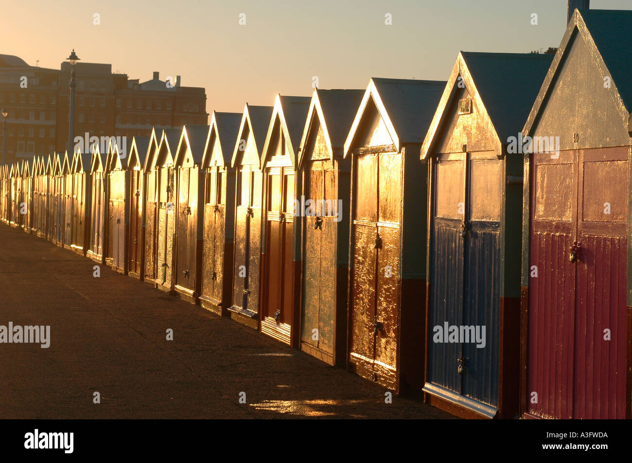 SUNSET ILLUMINATING BEACH HUTS ON BRIGHTON SEA FRONT Stock Photo - Alamy