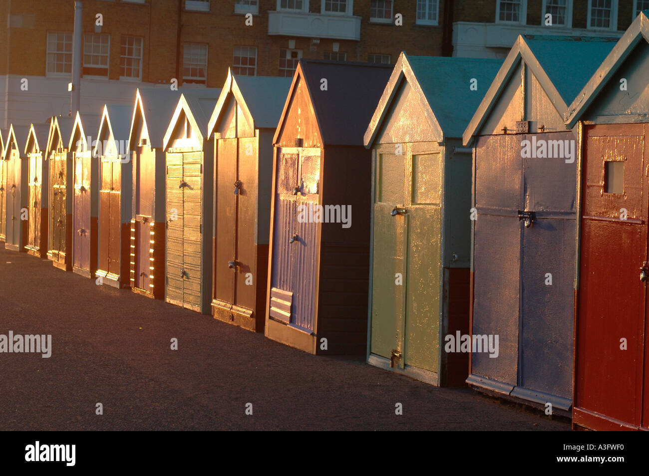 SUNSET ILLUMINATING BEACH HUTS ON BRIGHTON SEA FRONT Stock Photo - Alamy