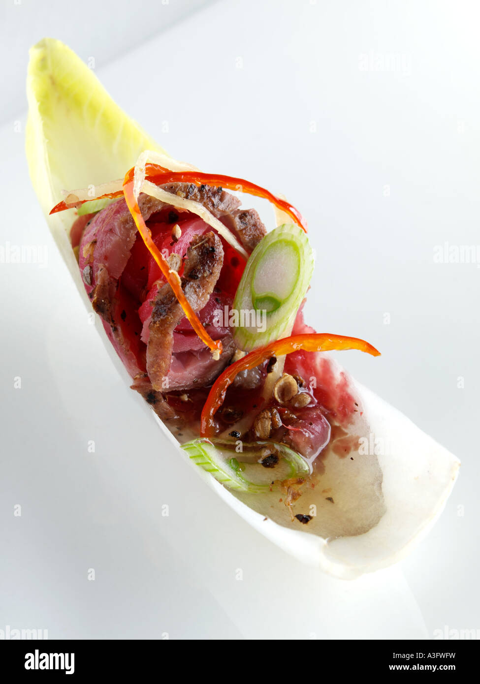 Beef canape in a chicory leaf editorial food Stock Photo - Alamy