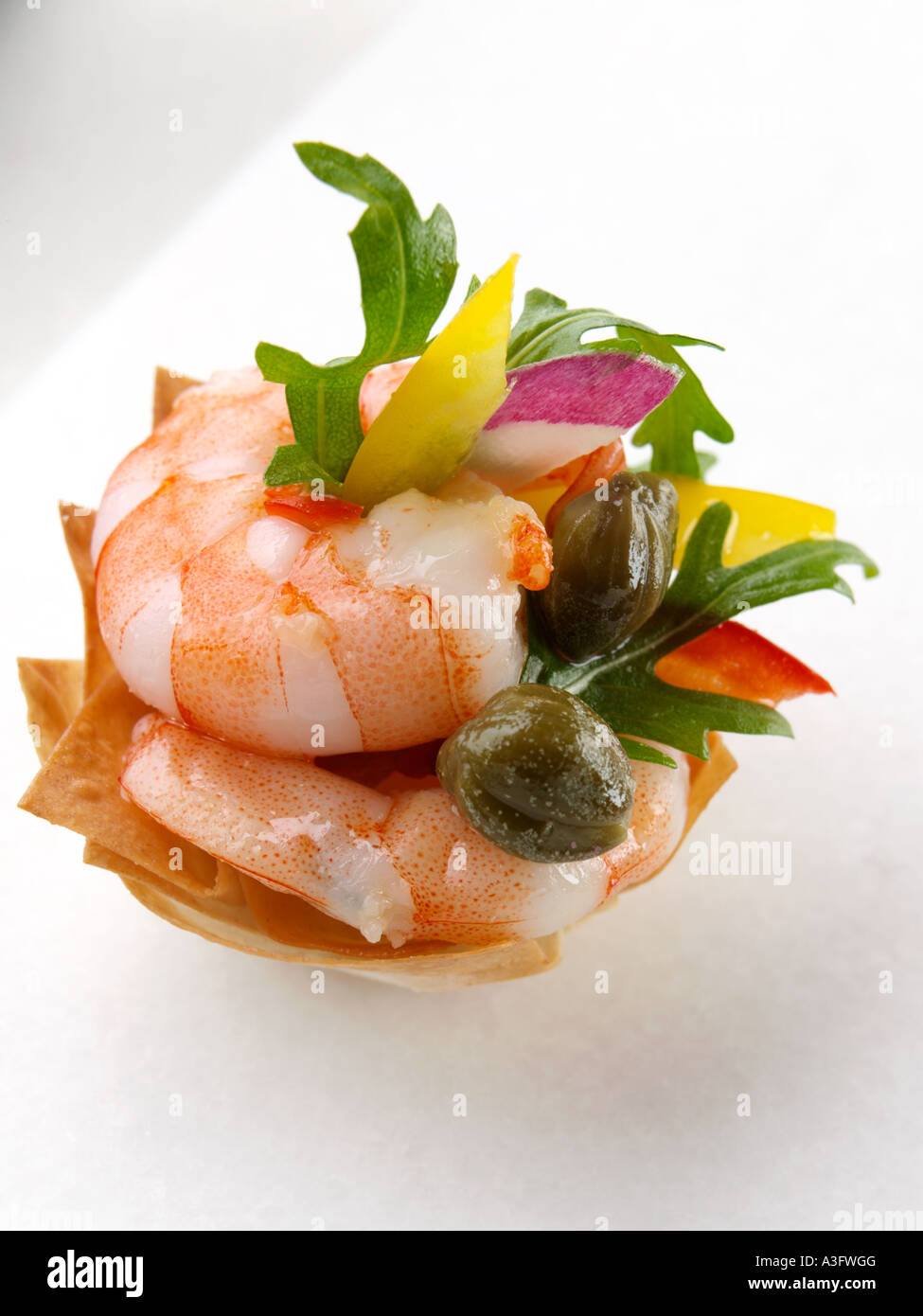 Marinated prawn filo cup canape on a white background graphic image ...