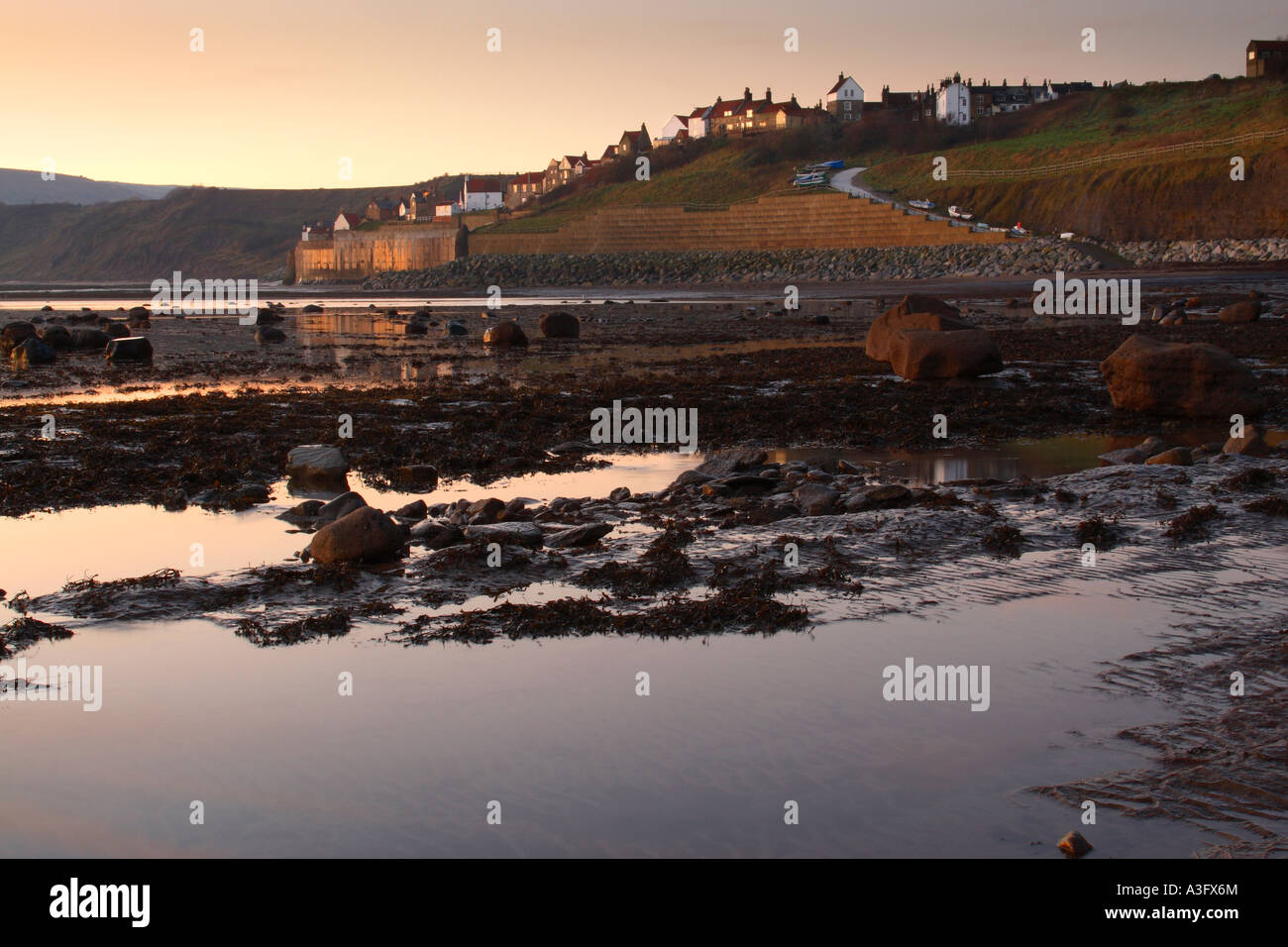 Fishing village of Robin Hoods Bay in North Yorkshire showing sea wall ...