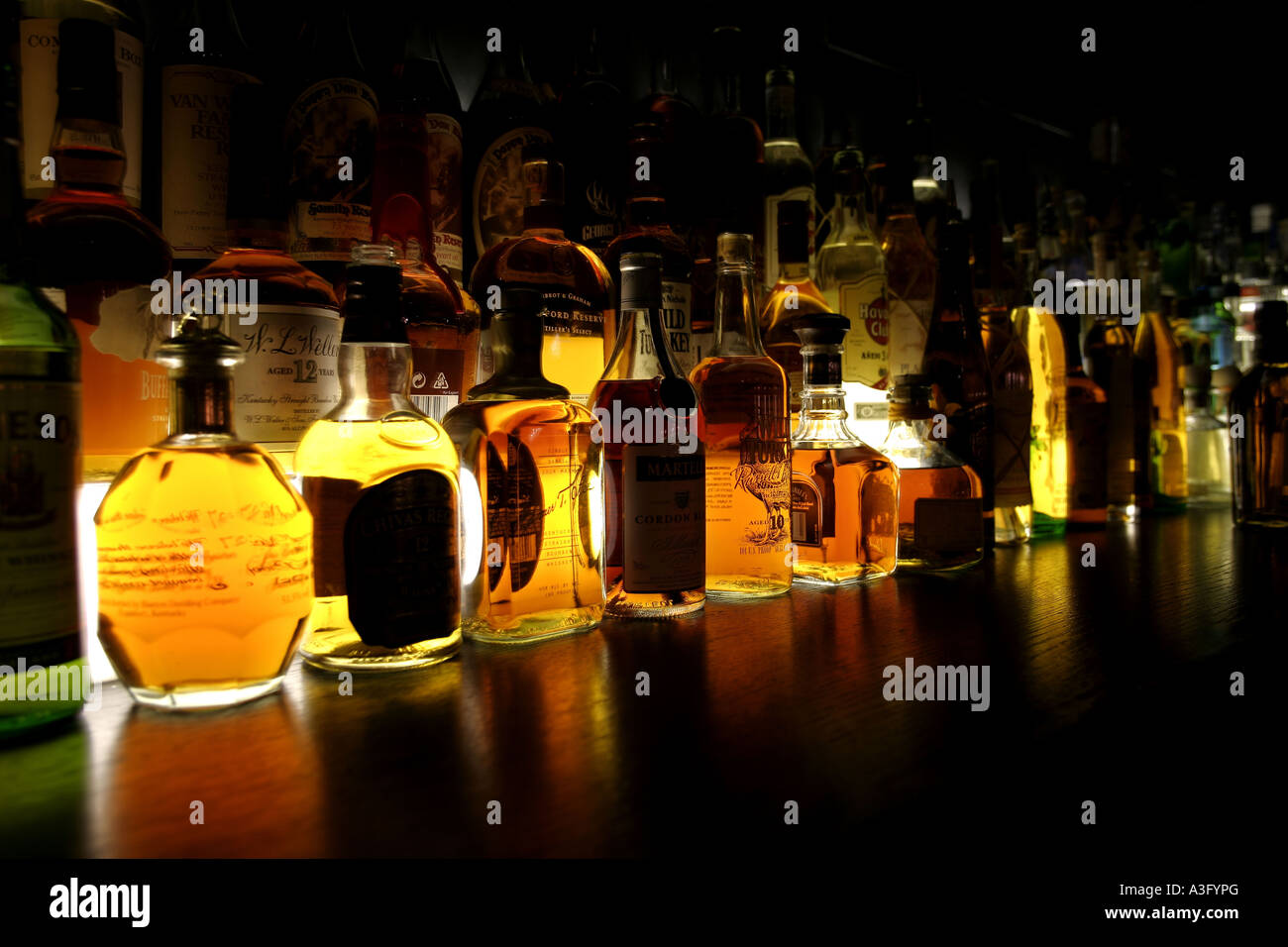 whiskey bottles on a back bar Stock Photo - Alamy