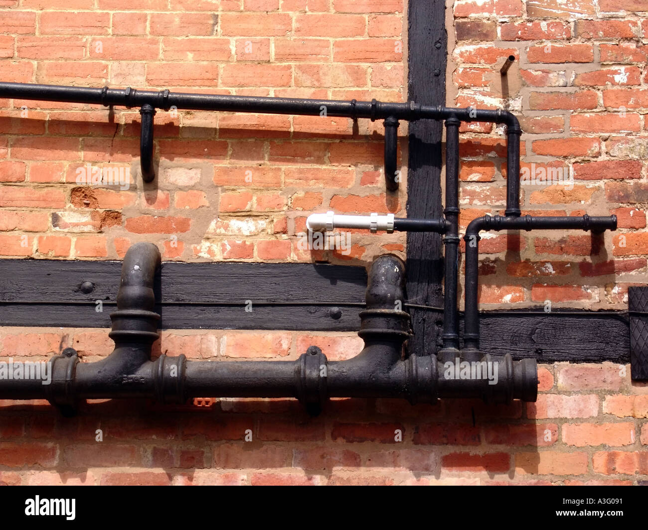pipes and bricks on wall Stock Photo - Alamy