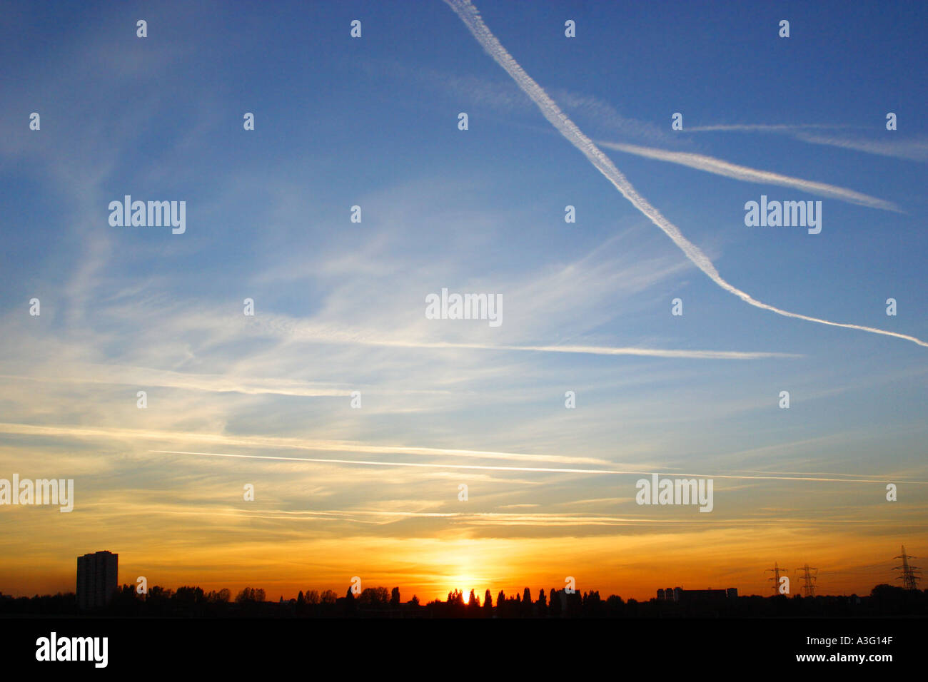 Aircraft contrails and blue sky at sunset Stock Photo - Alamy