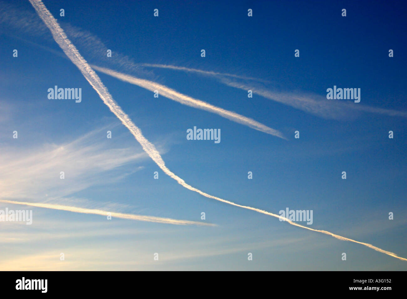 Aircraft contrails in blue sky Stock Photo - Alamy