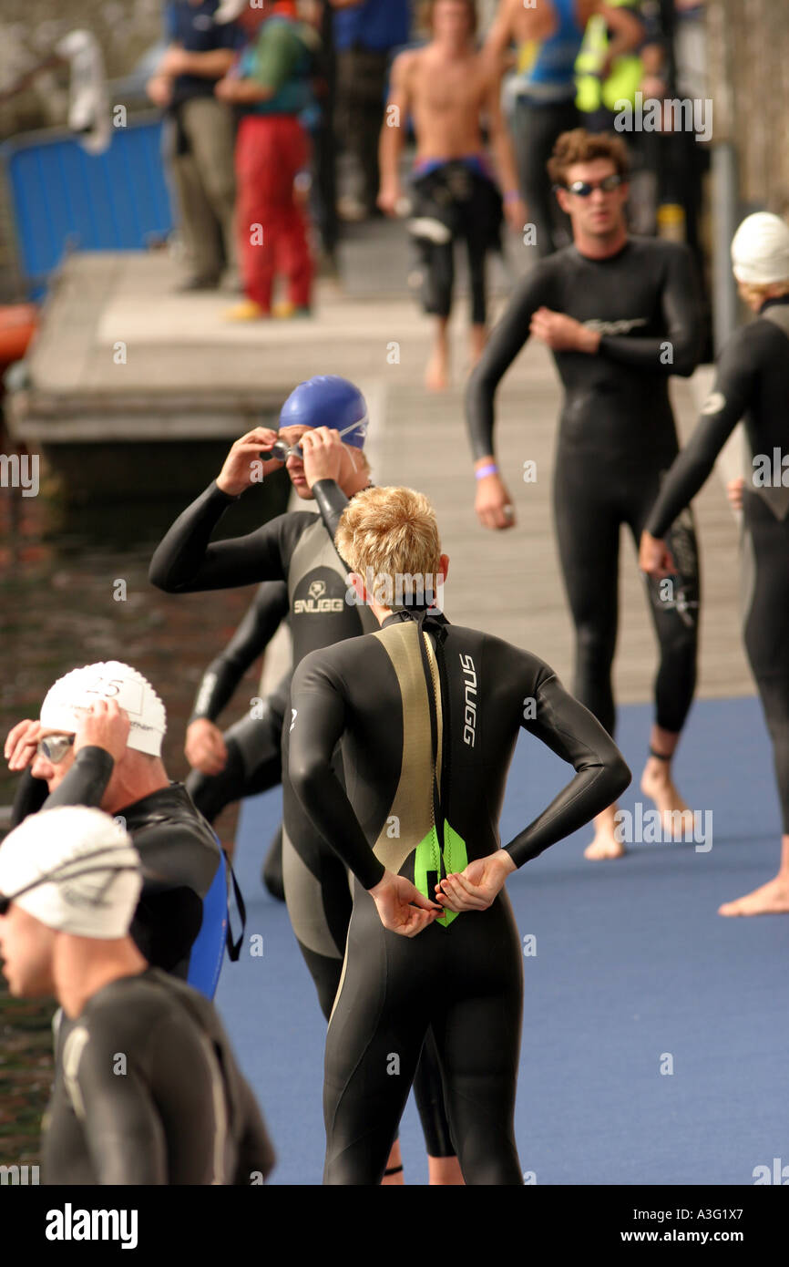 male triathletes in wetsuits prepare for the start of a triathlon Stock ...