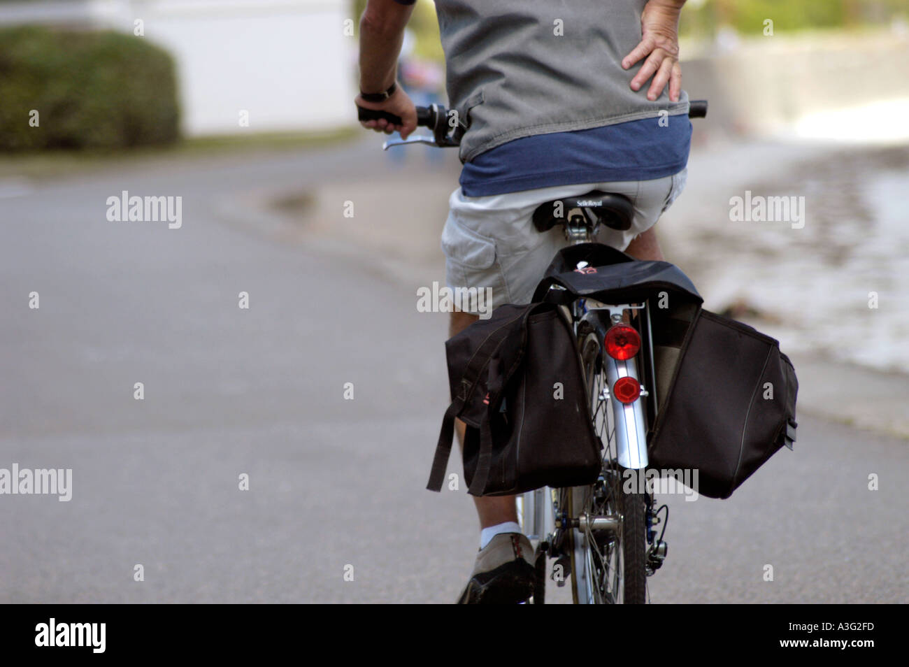 Cycling with a sore back Stock Photo - Alamy
