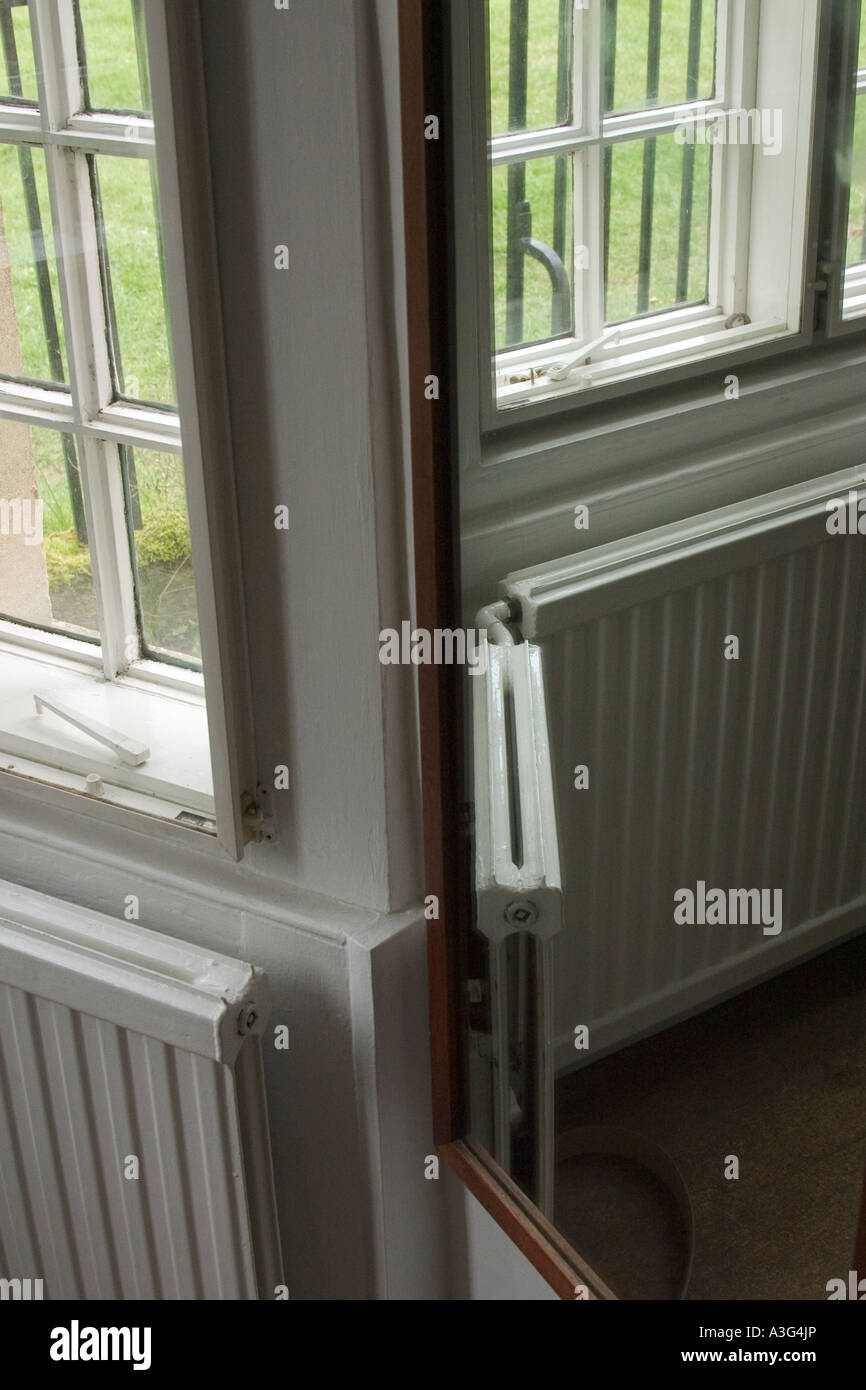 View into a bay window reflected in mirror on the wall Stock Photo - Alamy