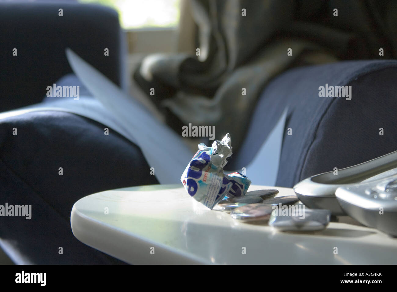 Close up of discarded sweet wrapper and badges on a table with a sofa ...