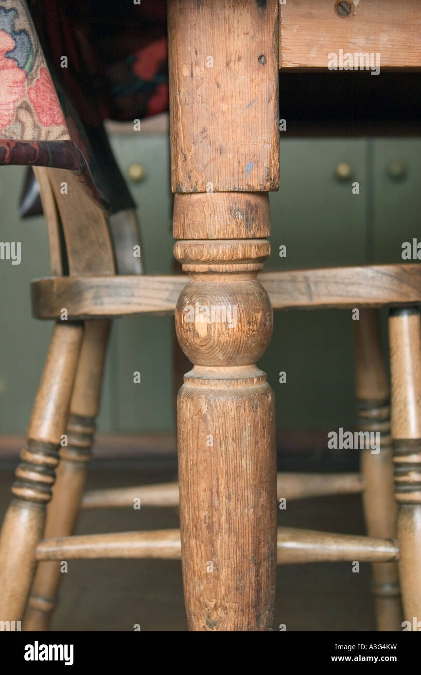 Close up of table leg and chair behind it Stock Photo - Alamy