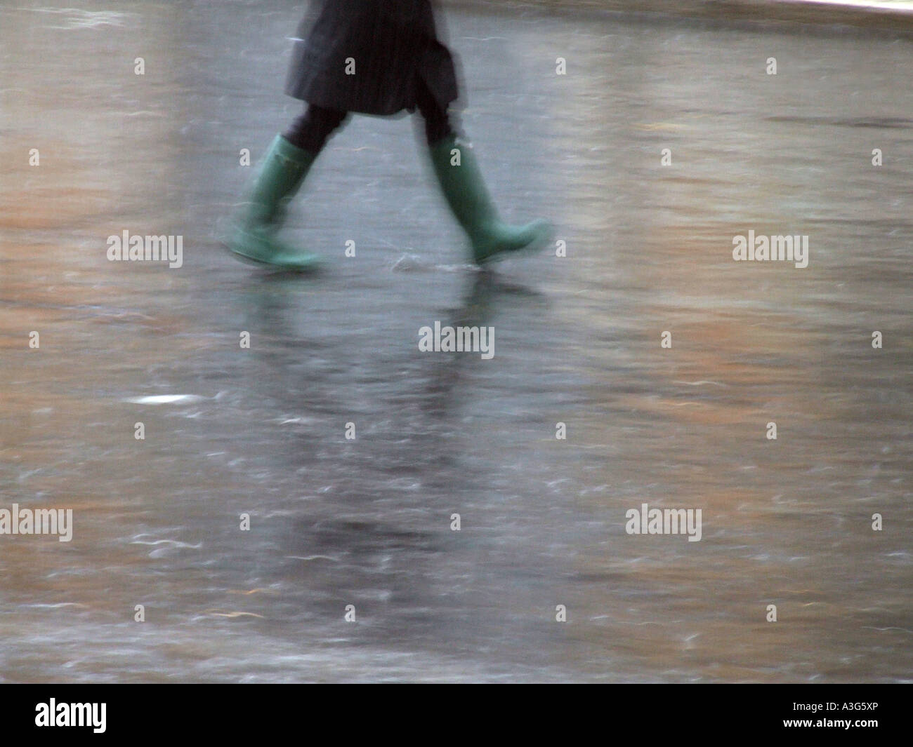 person walking in rain in town Stock Photo - Alamy