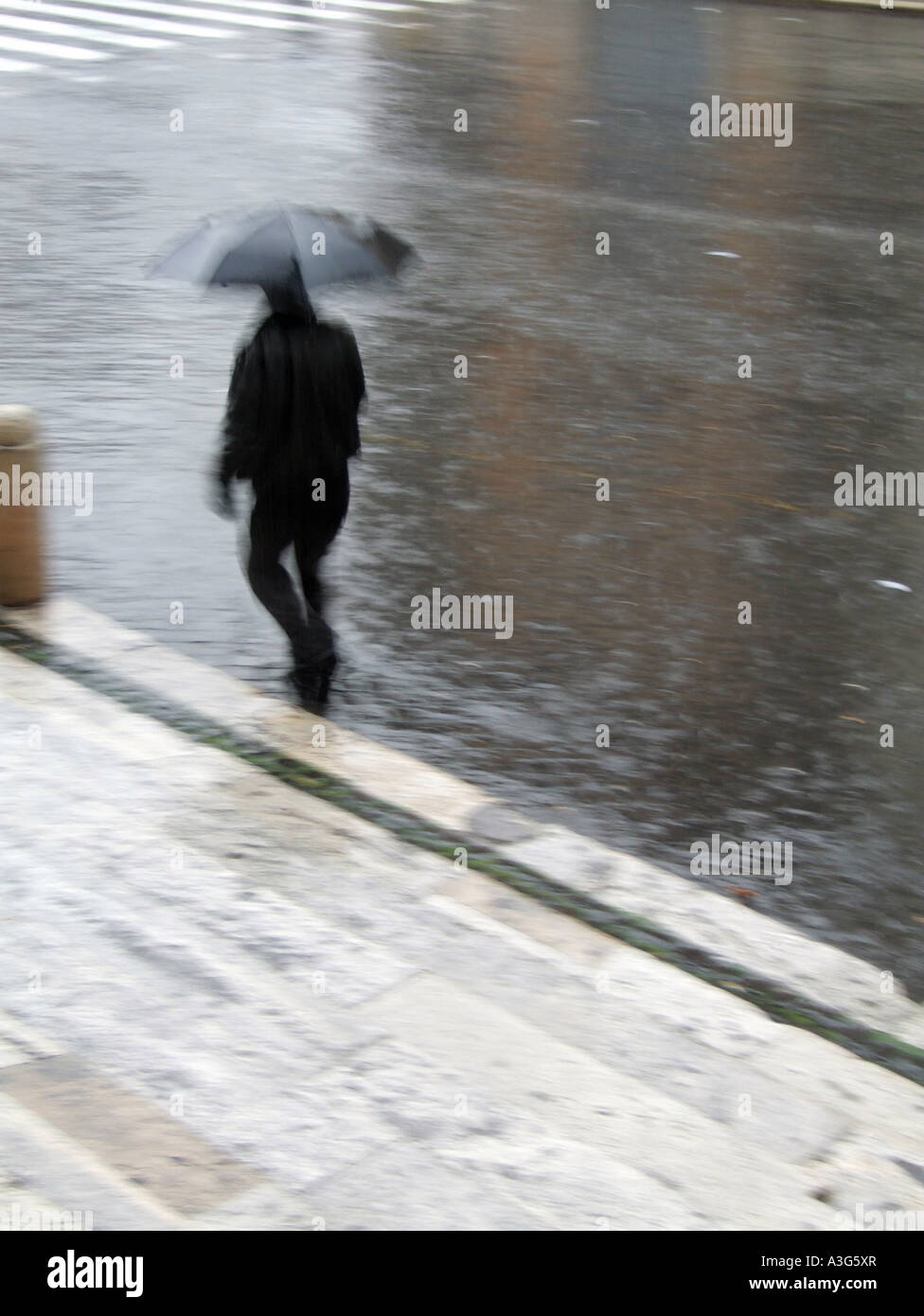 person carrying umbrella in town Stock Photo - Alamy