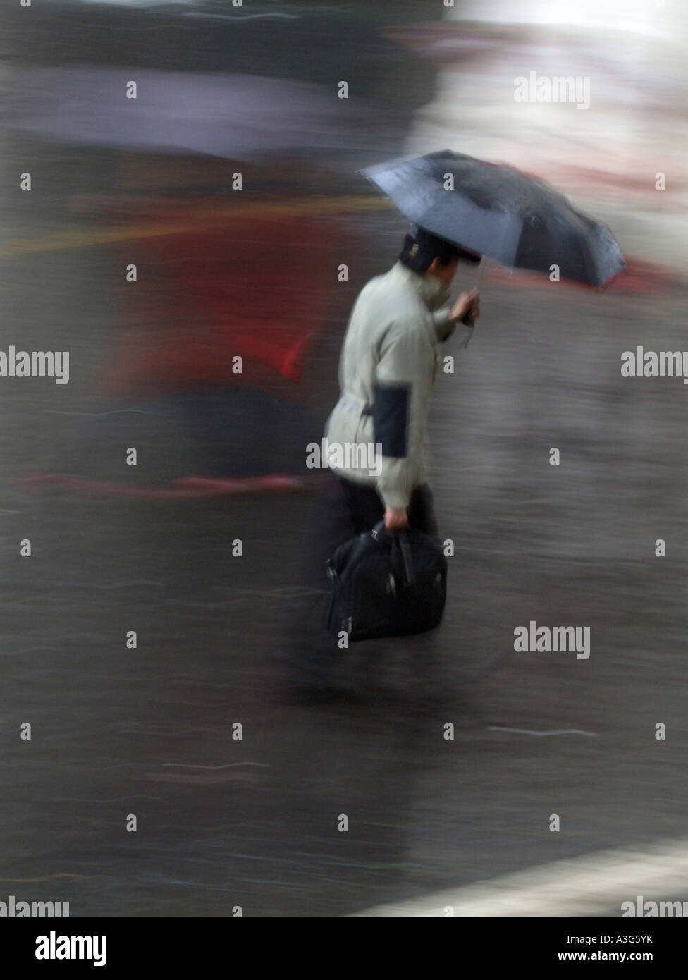 person carrying umbrella in town Stock Photo - Alamy