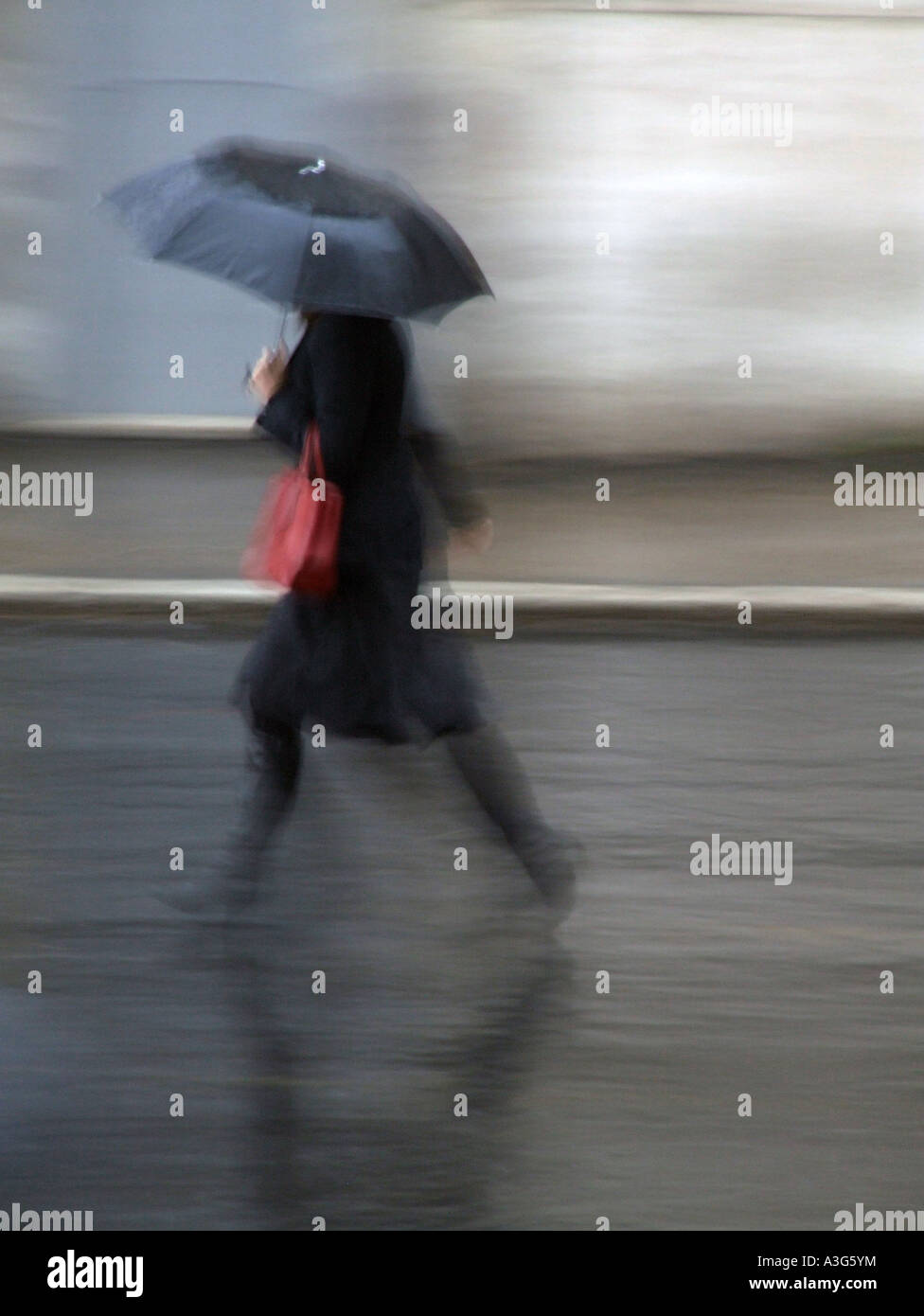 person carrying umbrella in town Stock Photo - Alamy