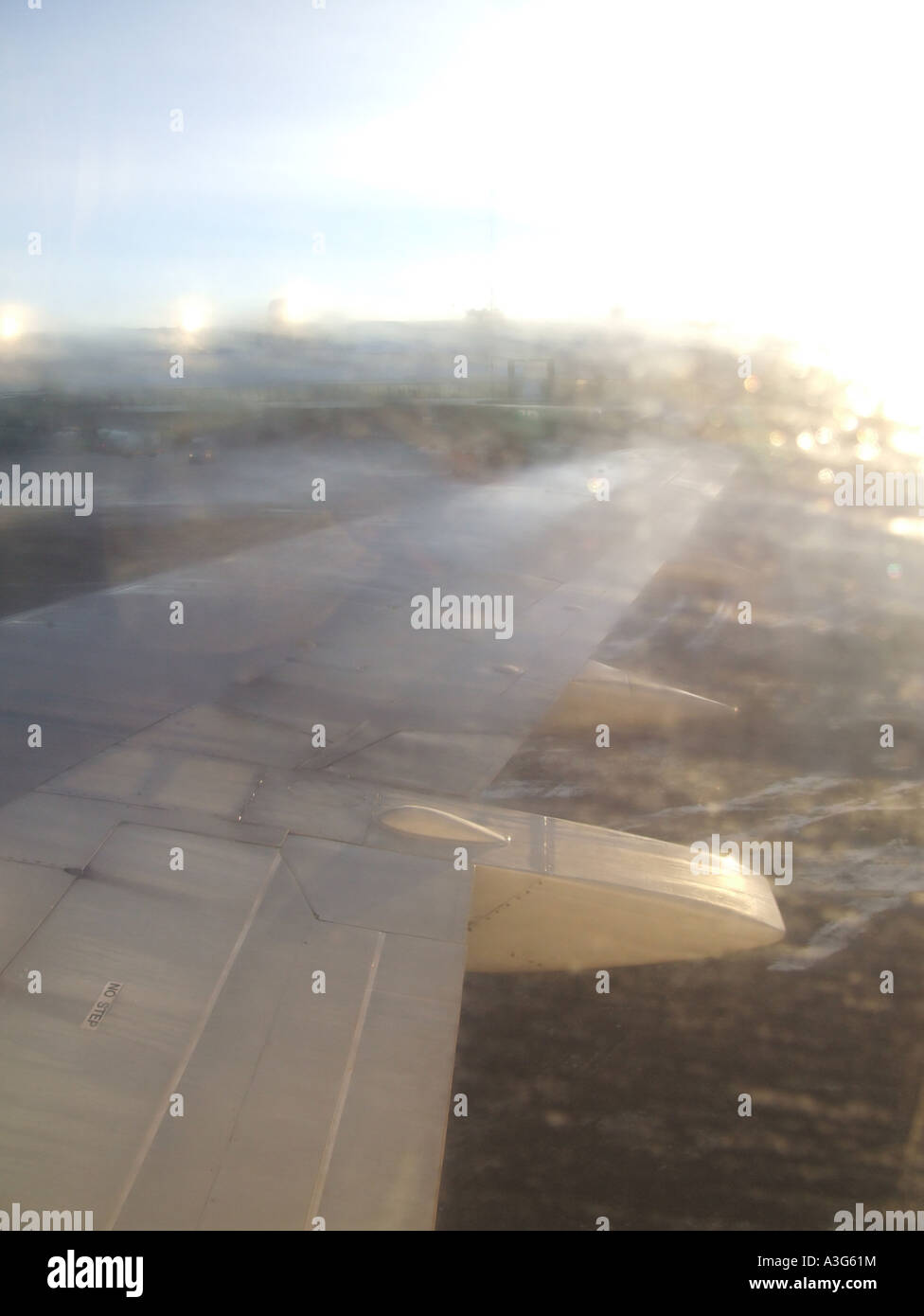 view of budget carrier plane wing and sunset on take off Stock Photo ...