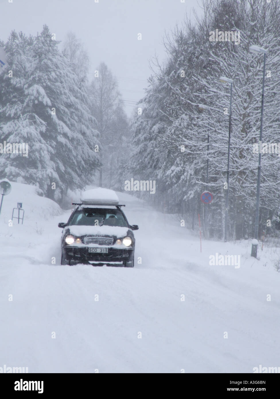 car driving in heavy snow on rural road Stock Photo - Alamy