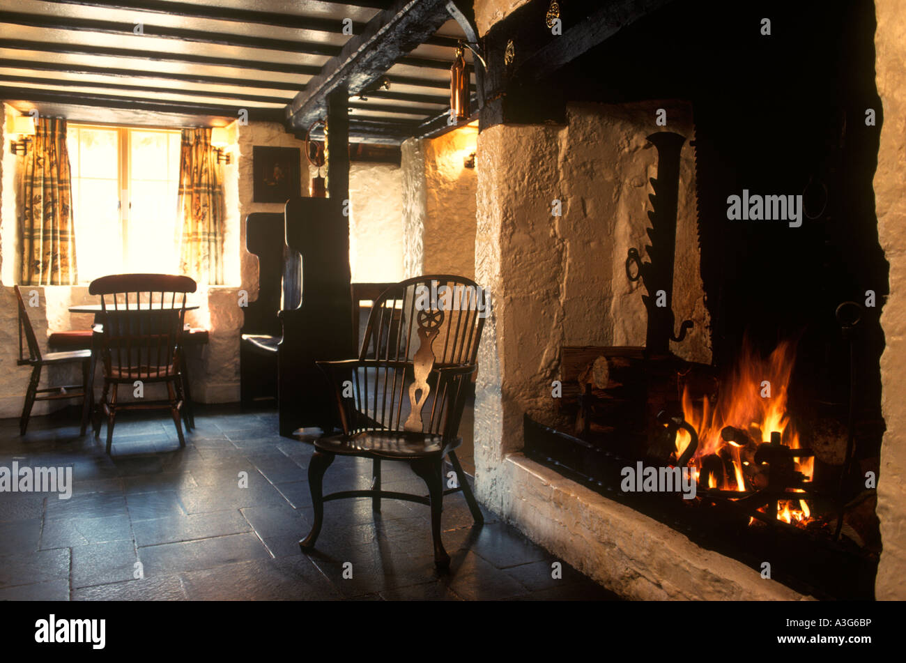English pub interior UK. Real log fire open hearth stone fireplace ...