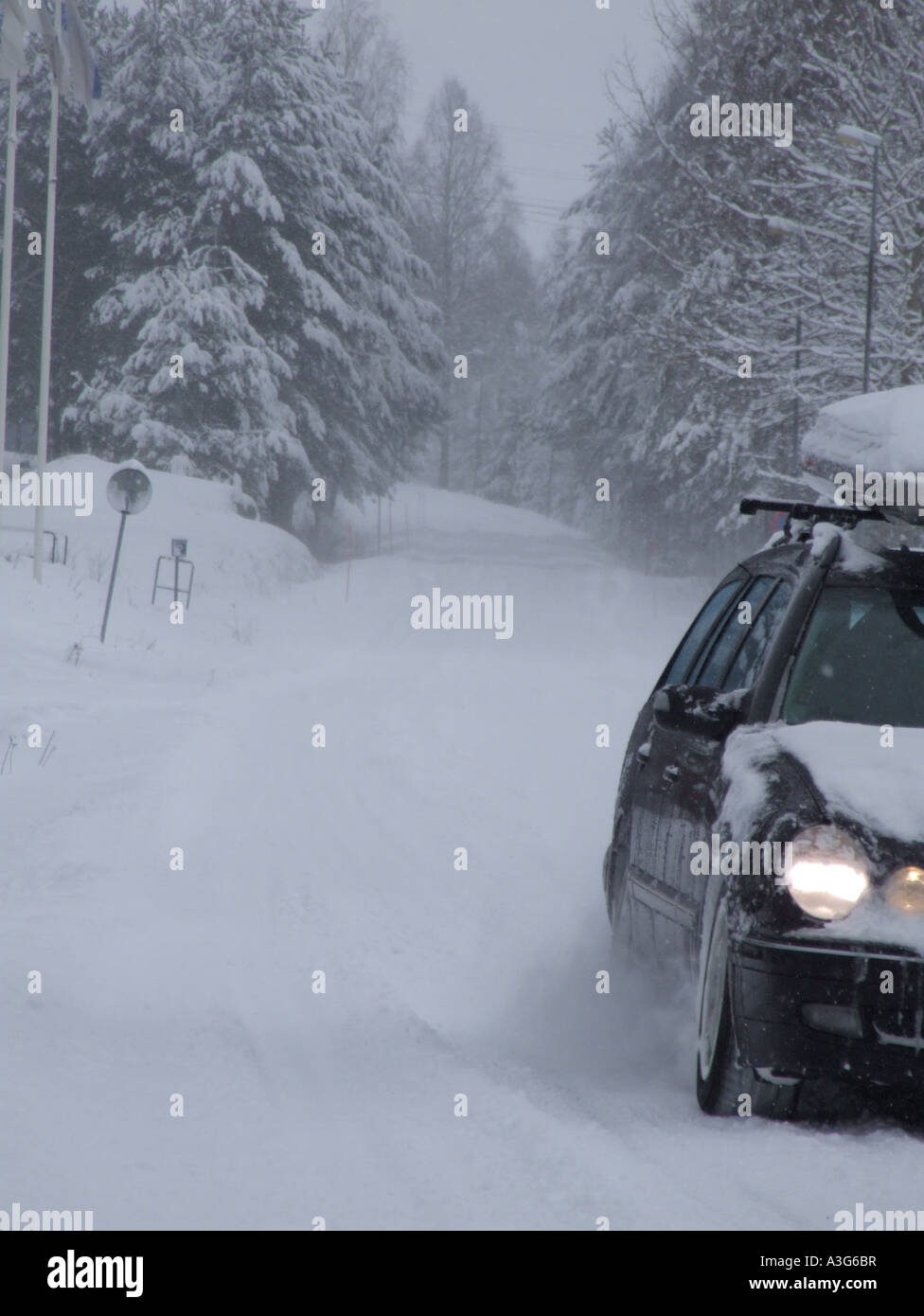car driving in heavy snow on rural road Stock Photo - Alamy