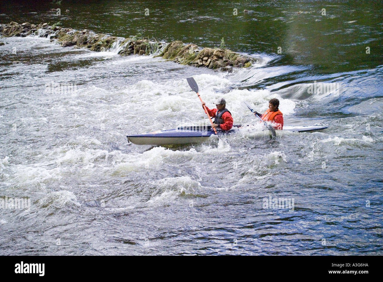 Canoeists shooting the rapids in a double canoe on the River Wye at ...
