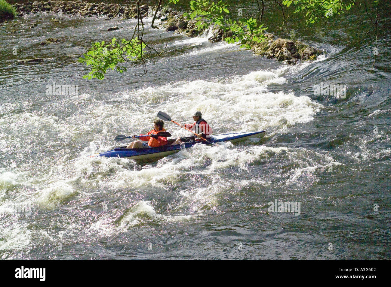 Canoeists shooting the rapids on the River Wye at Symonds Yat ...