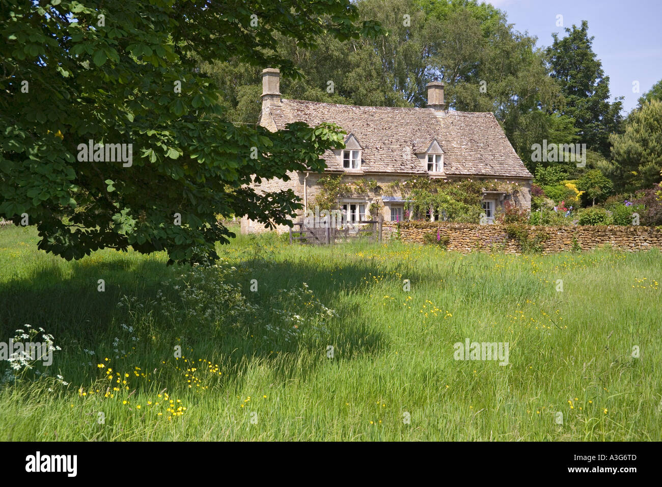 A cottage on the village green in the Cotswold village of Wyck ...