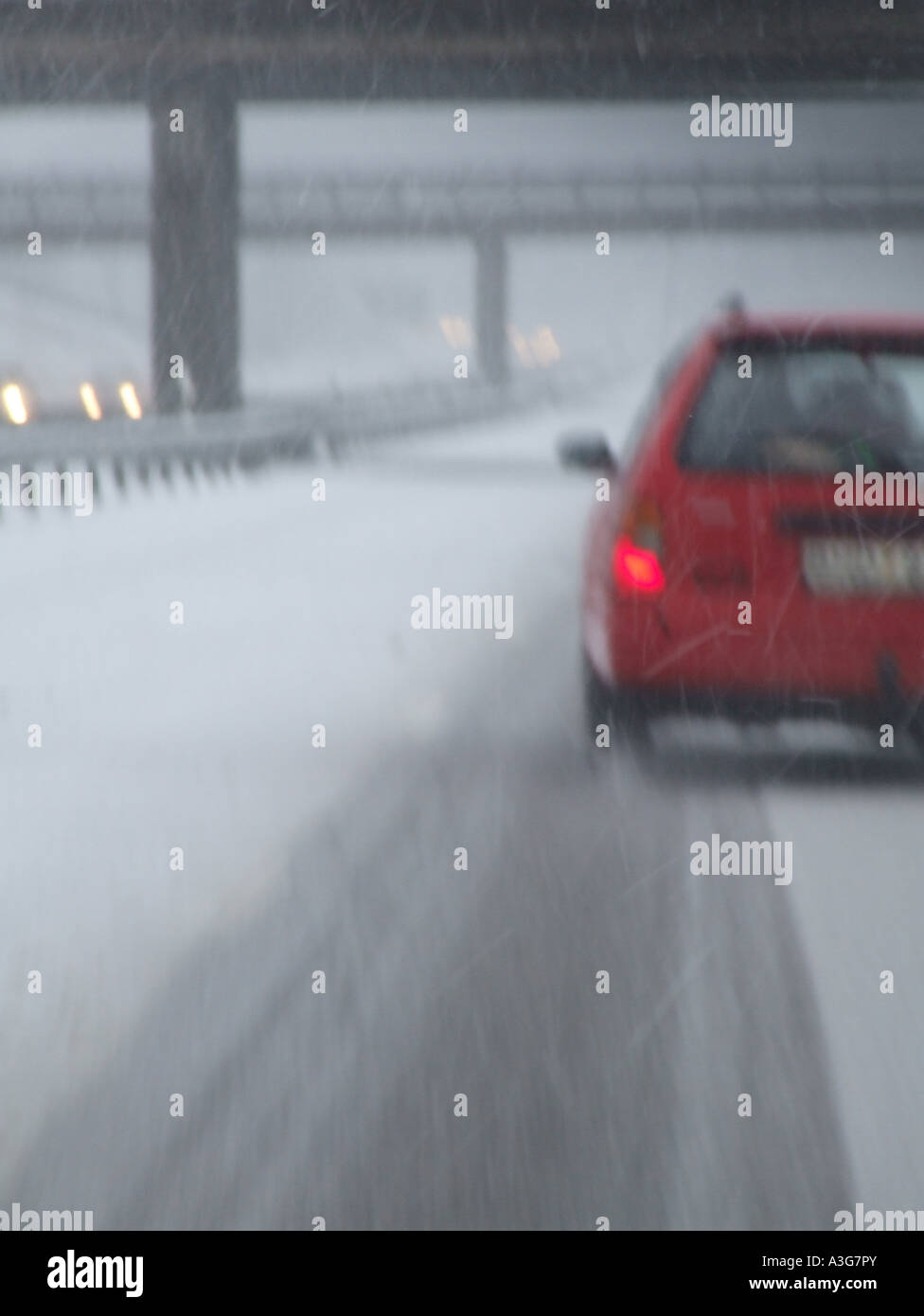 one red car driving in heavy snow in sweden Stock Photo - Alamy