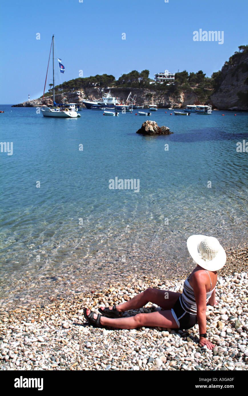 Woman sitting on beach at Patitiri Alonissos Island Greece Stock Photo ...