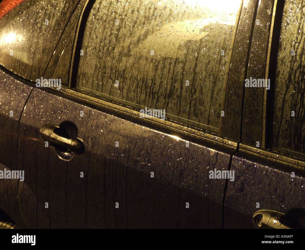 side of wet car in rain at night Stock Photo - Alamy