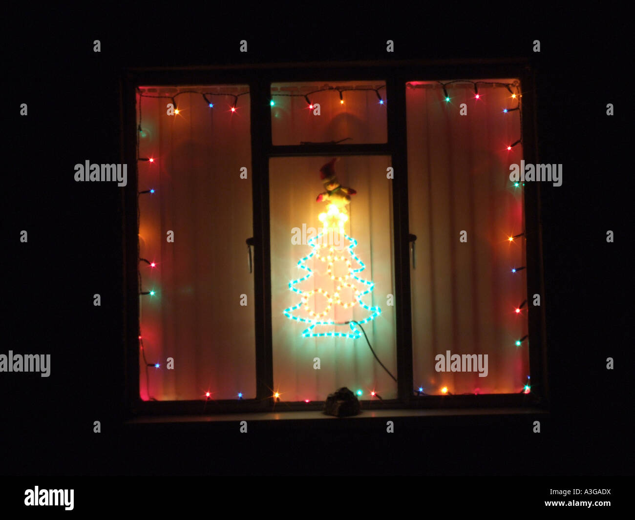 colourful chritmas lights in home window Stock Photo - Alamy