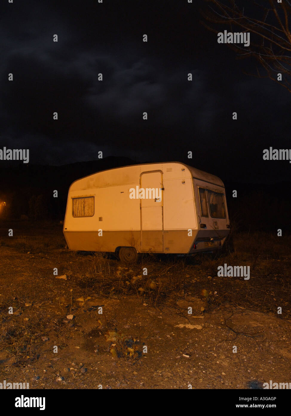 one caravan on derelict ground at night Stock Photo - Alamy