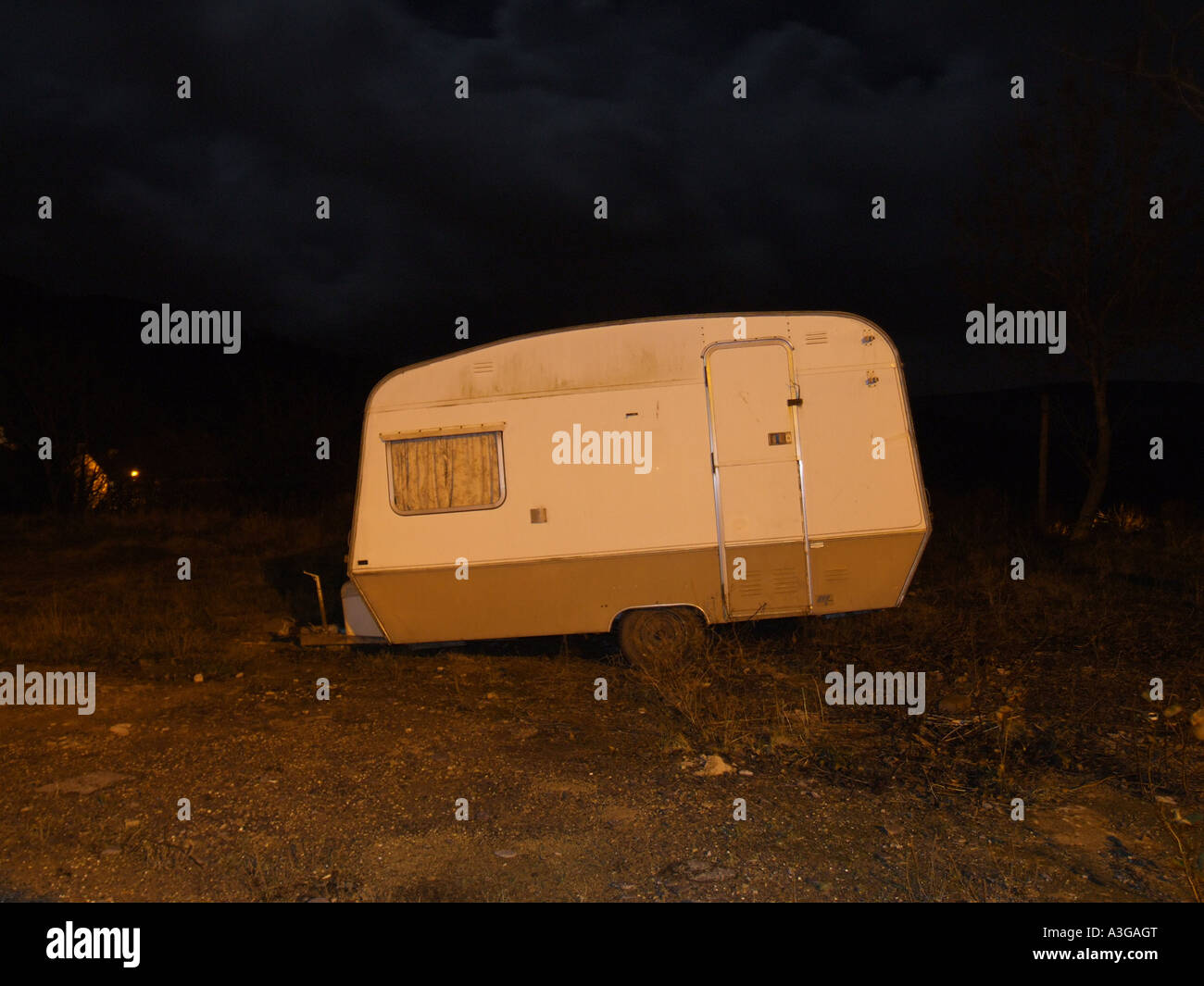 one caravan on derelict ground at night Stock Photo - Alamy