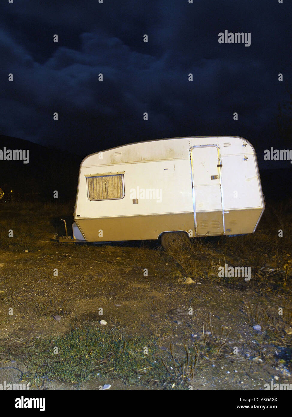 one caravan on derelict ground at night Stock Photo - Alamy